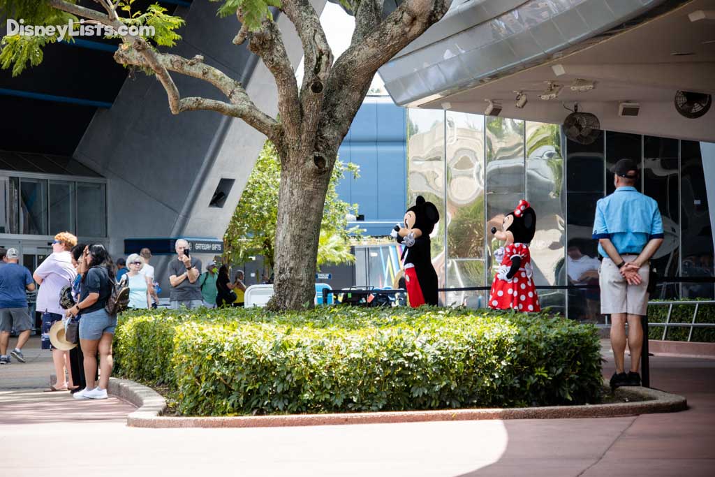 Mickey and Minnie greet guests from a distance at EPCOT. – DisneyLists.com